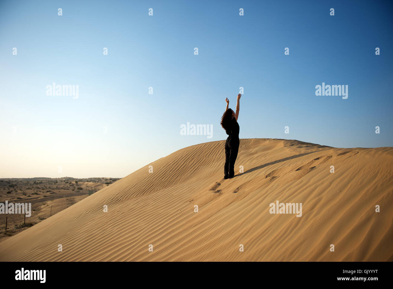 Woman in the desert Stock Photo - Alamy