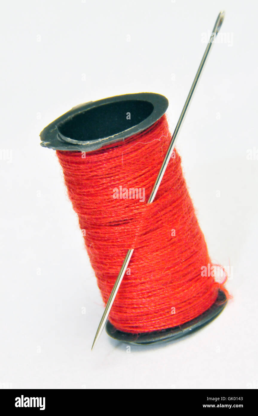 Spool of thread and needle Stock Photo - Alamy