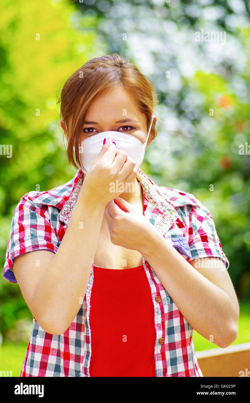 women with colorfull clothes adjusting his mask Stock Photo - Alamy