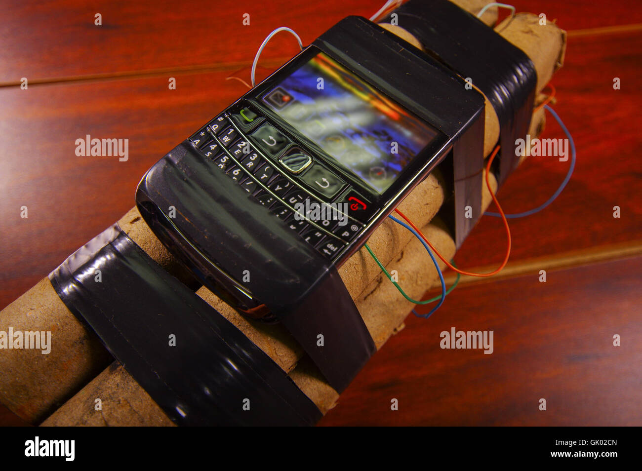 cellphone conected to aexplosives laying on the ground Stock Photo - Alamy