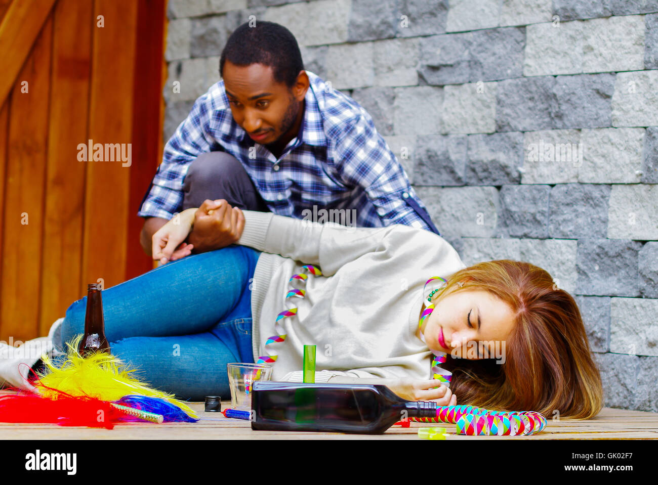 Woman Wearing Casual Clothes Lying Drunk Passed Out On Wooden Surface