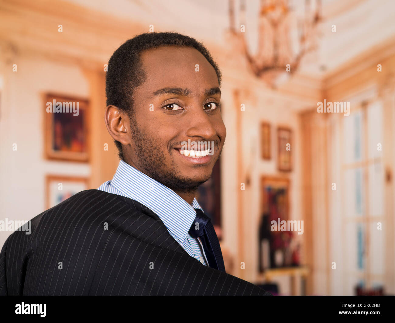 Headshot handsome man wearing business suit turning head and smiling to ...