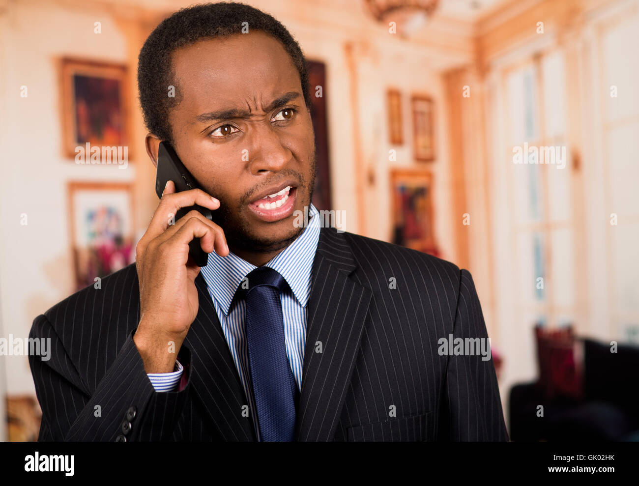Handsome man wearing business suit talking on mobile phone, as seen ...