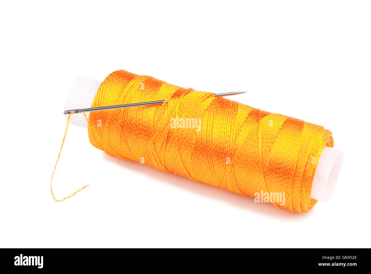 orange spool with needle Stock Photo - Alamy