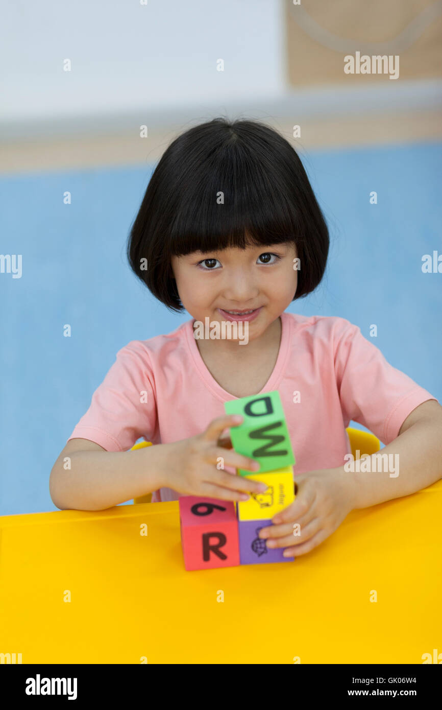 The little girl building blocks Stock Photo - Alamy