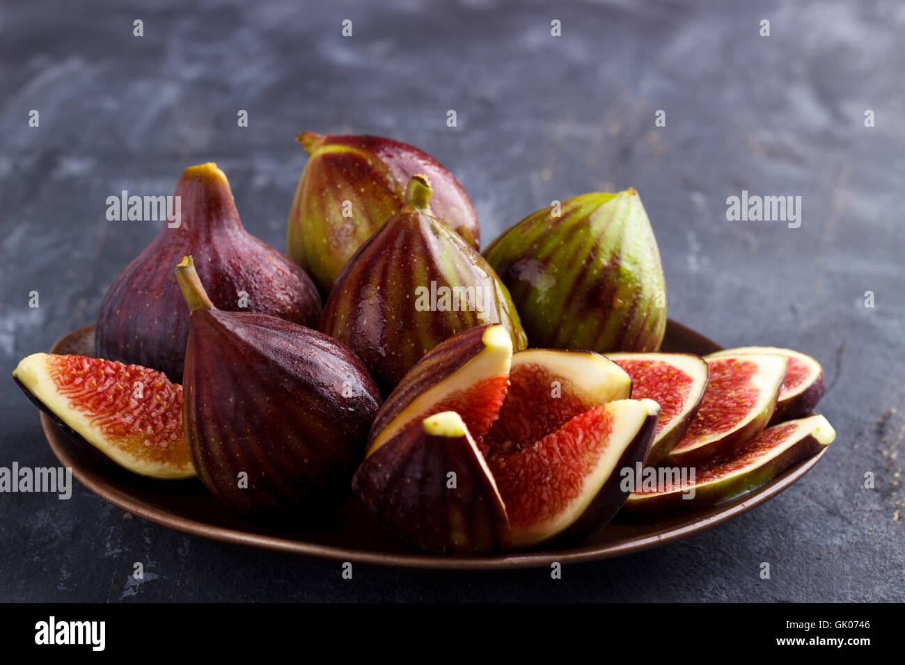 Ripe figs on dark rustic background,selective focus Stock Photo - Alamy