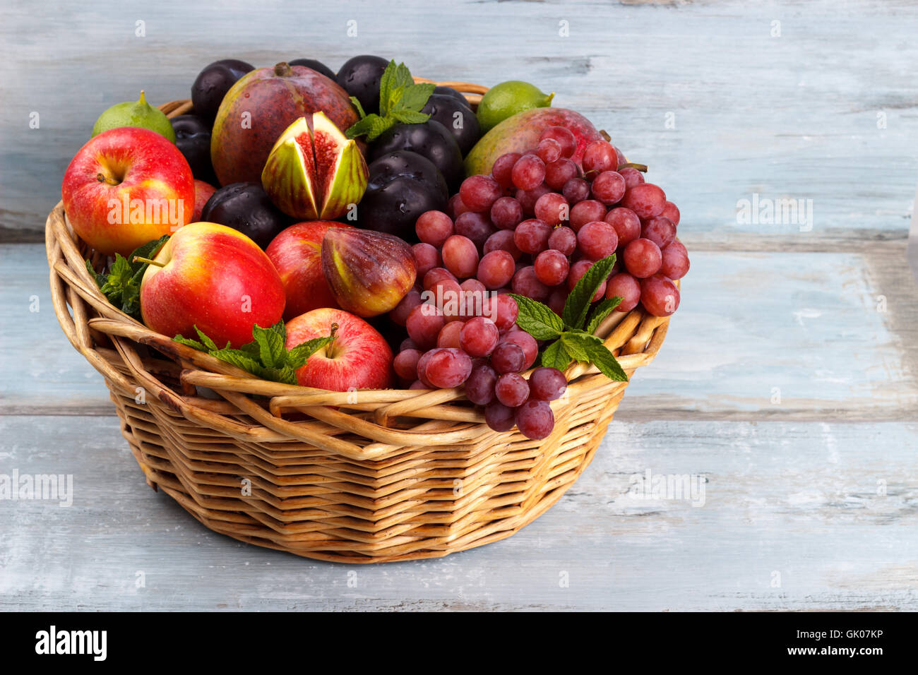 Basket of fresh organic fruits in the garden on rustic background Stock ...