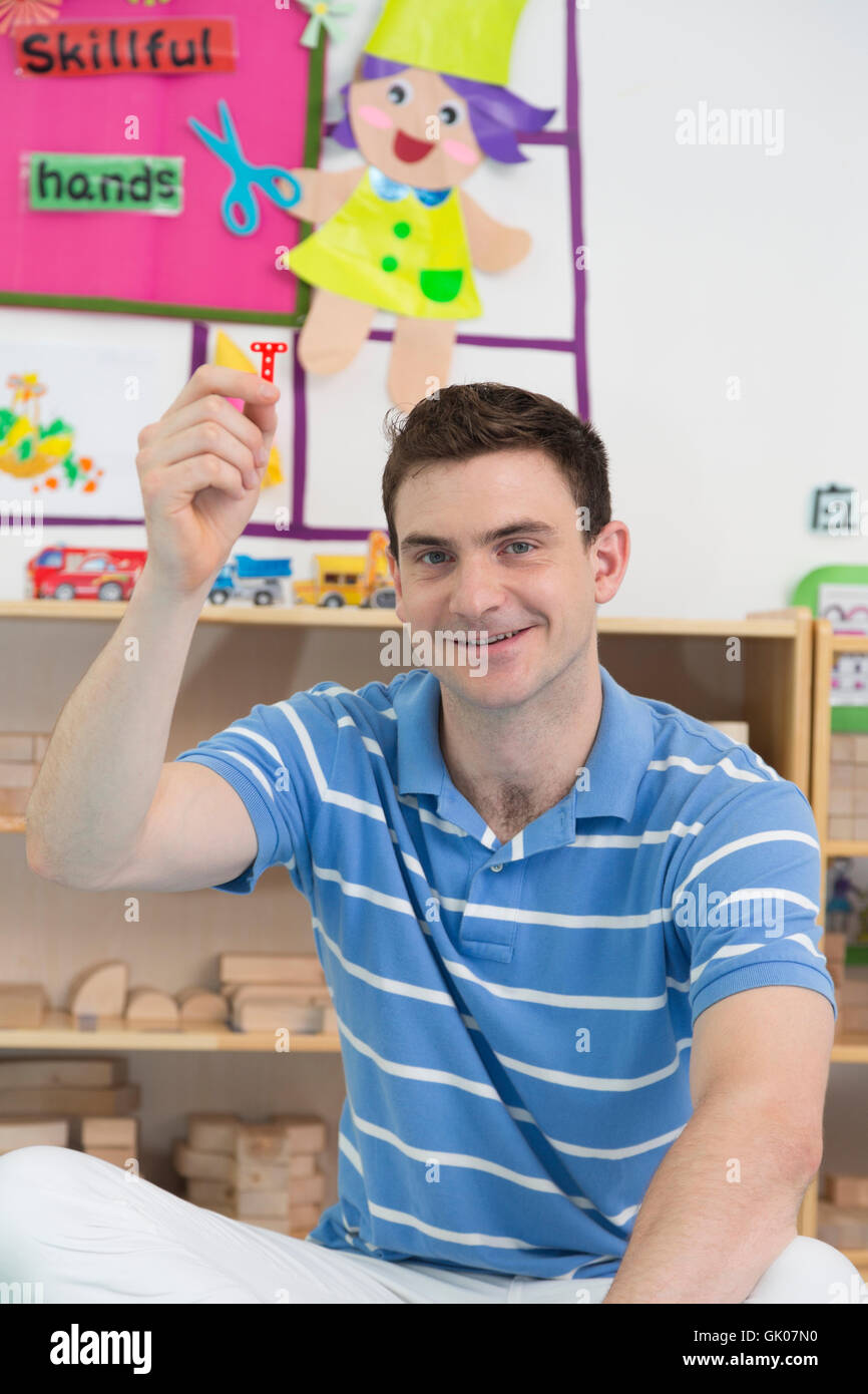 Male teacher in kindergarten Stock Photo - Alamy