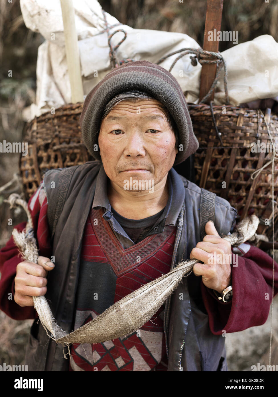 A man near Lukla, Nepal carries his products across the Himalayan ...
