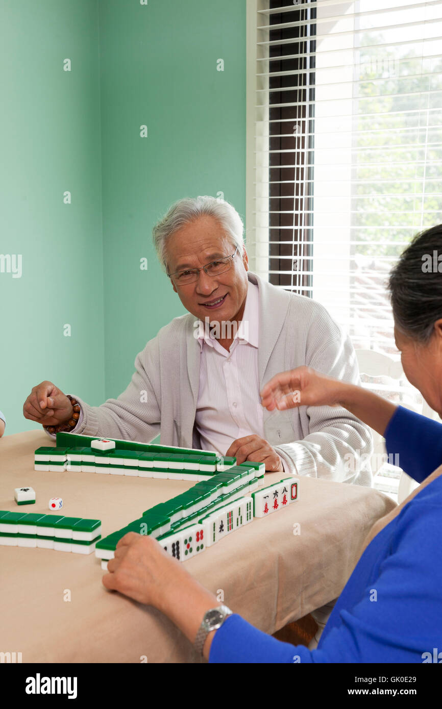 Chinese family playing mahjong hi-res stock photography and images - Alamy