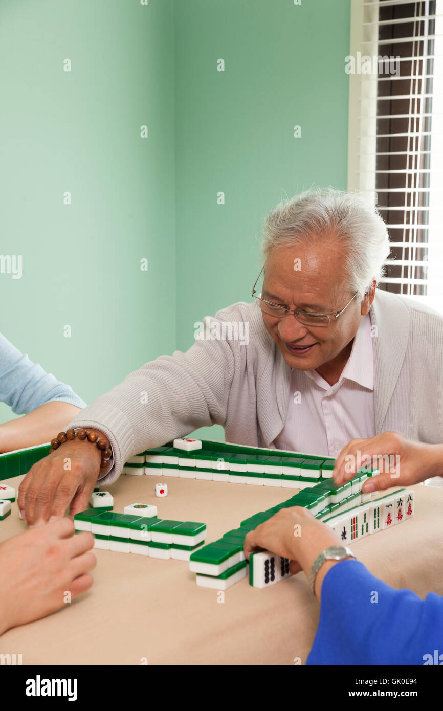 A people playing mahjong Stock Photo - Alamy