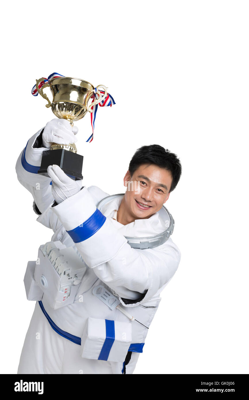 Studio shot male astronauts show trophy Stock Photo - Alamy