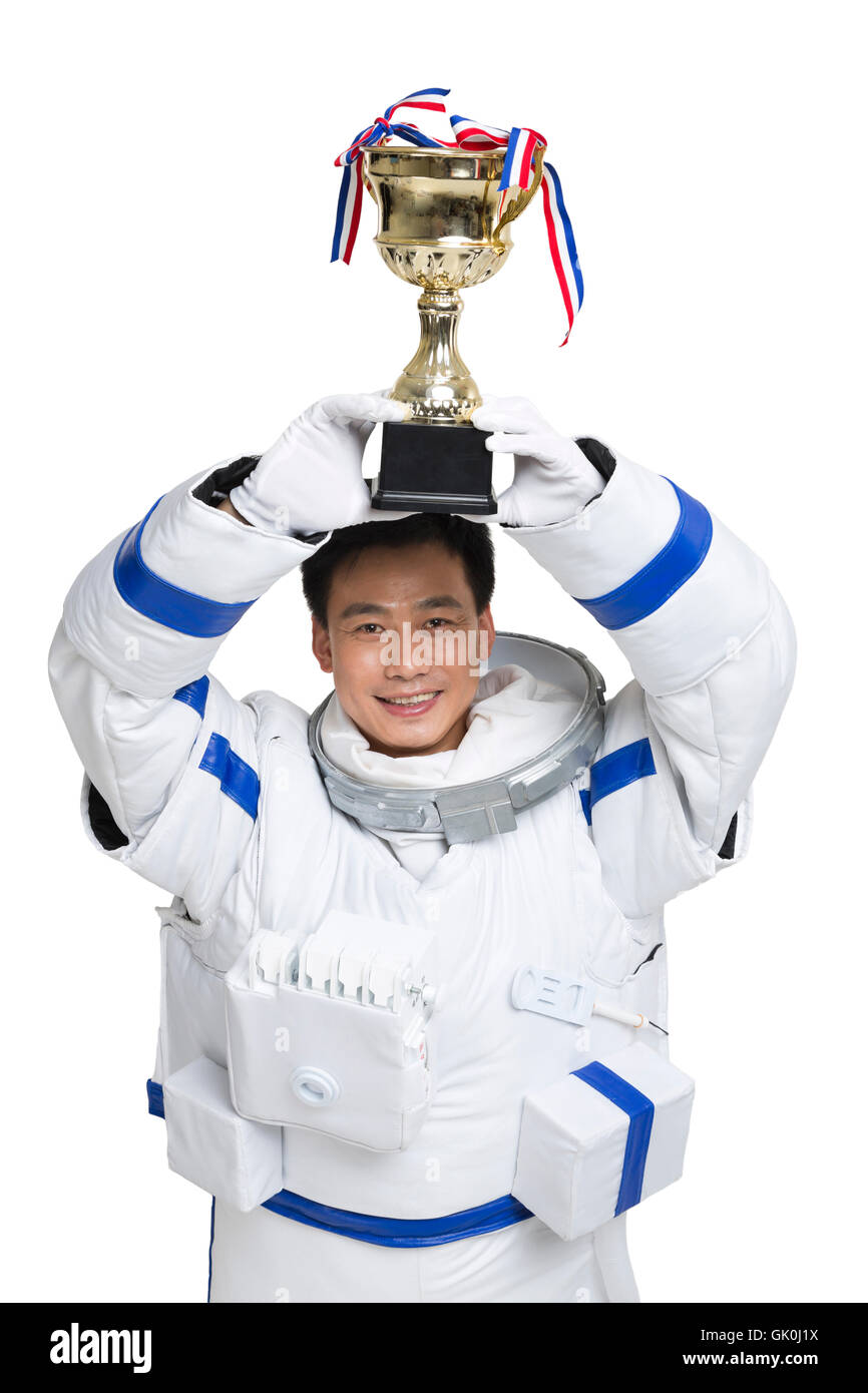 Studio shot male astronauts show trophy Stock Photo - Alamy