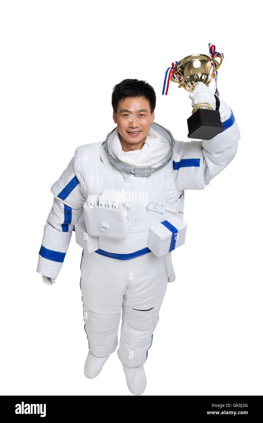 Studio shot male astronauts show trophy Stock Photo - Alamy