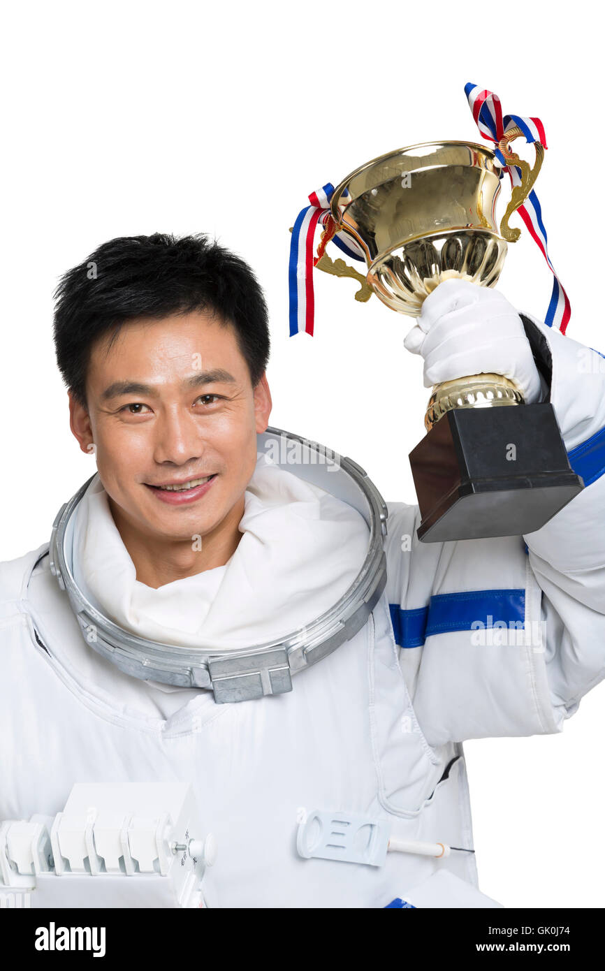 Studio shot male astronauts show trophy Stock Photo - Alamy