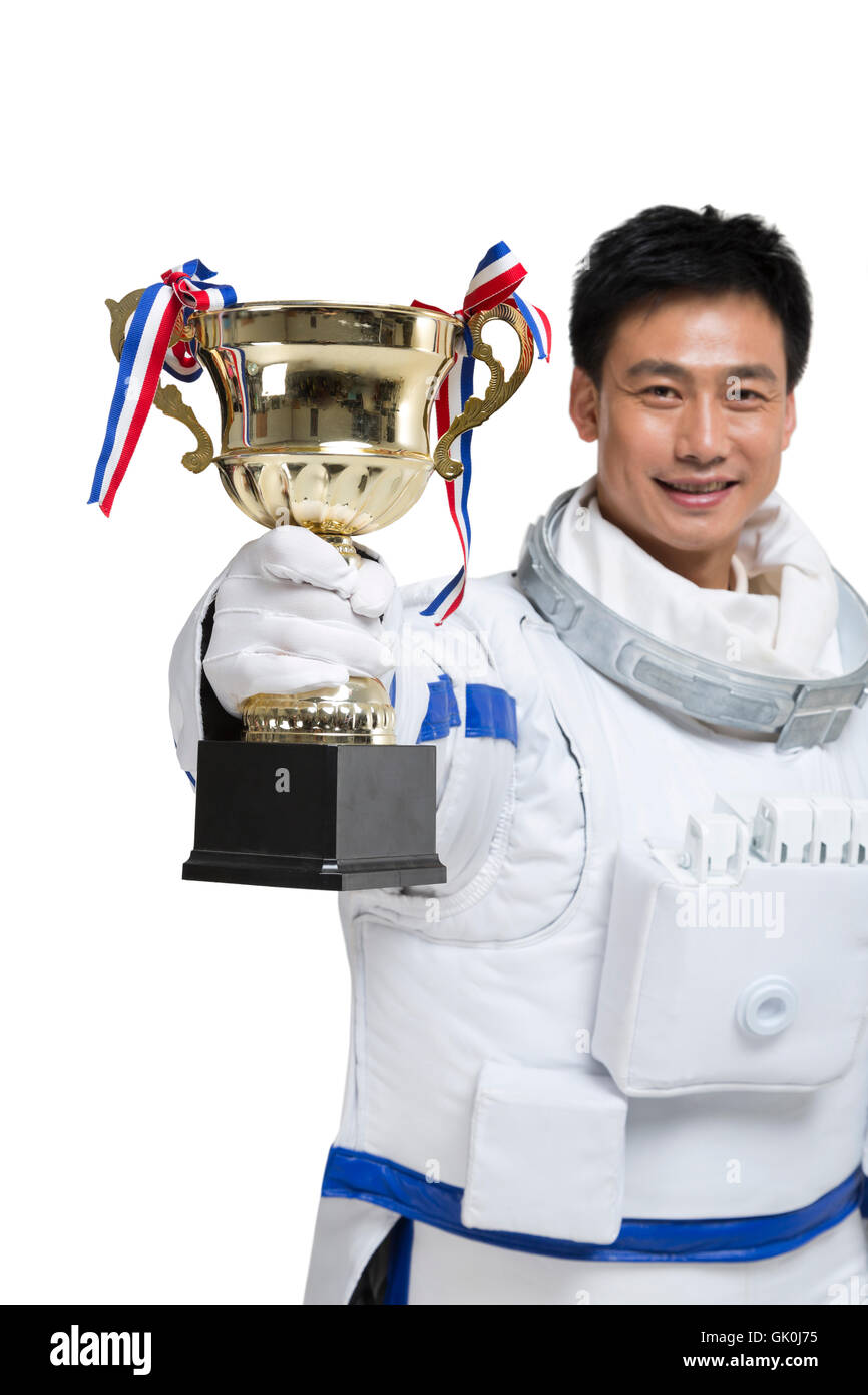 Studio shot male astronauts show trophy Stock Photo - Alamy