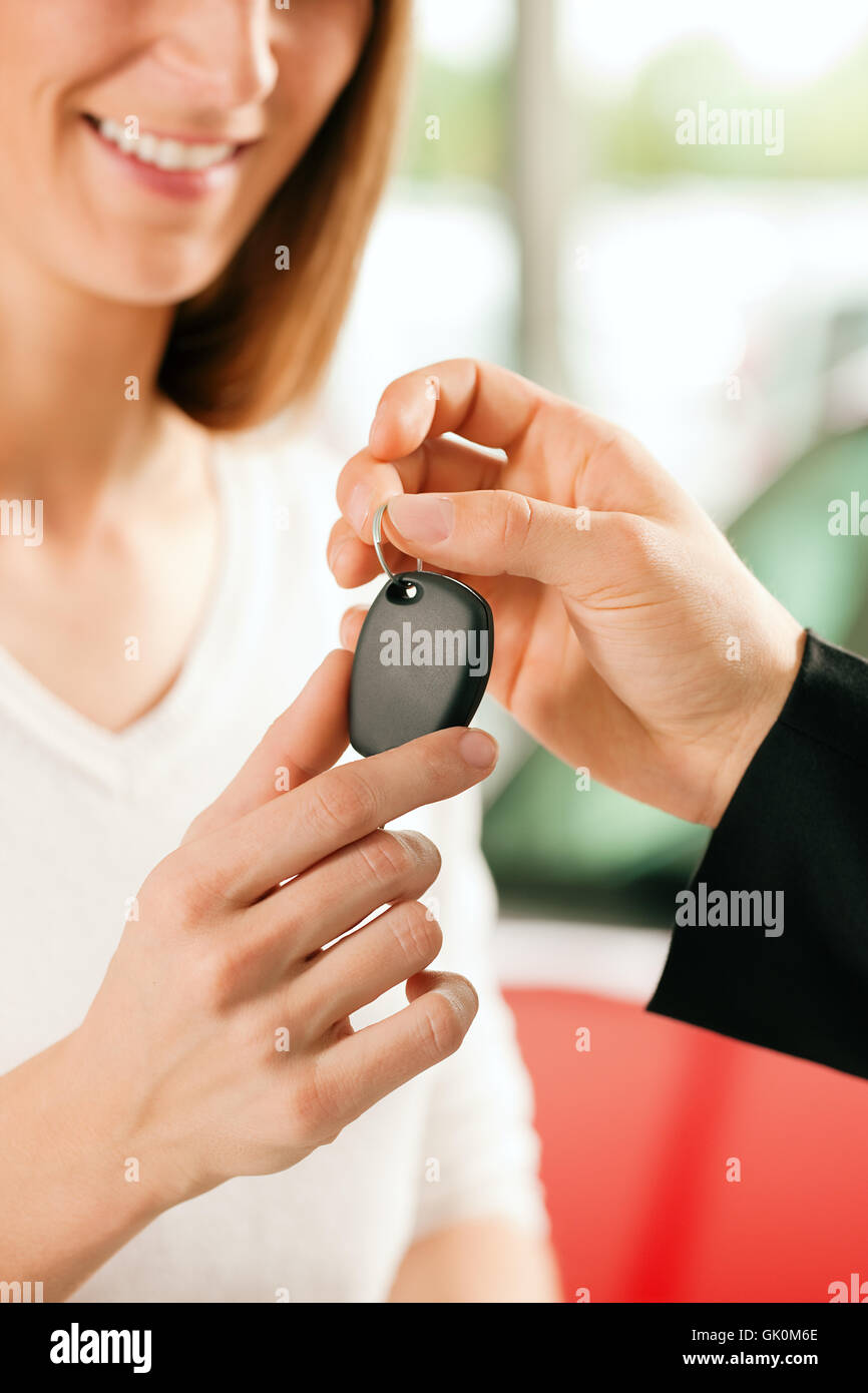 woman buying car - key handover Stock Photo - Alamy