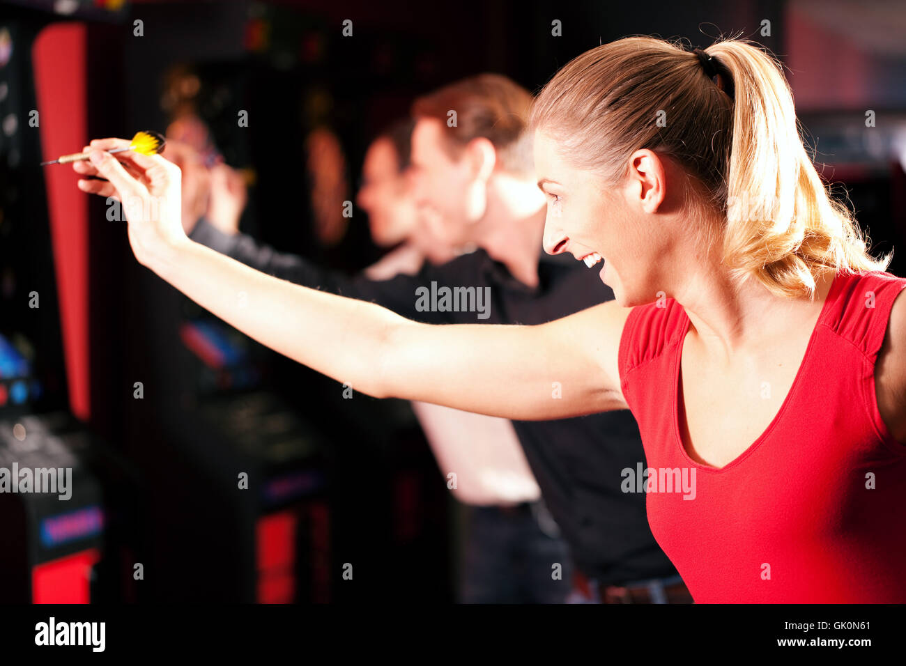 group of friends playing darts Stock Photo - Alamy