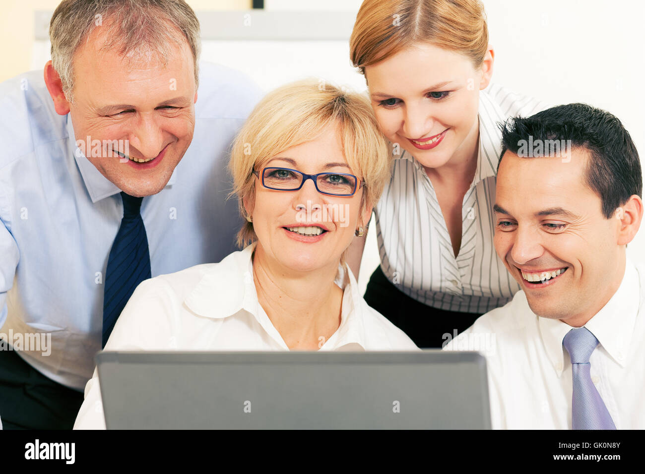 business team working at a computer Stock Photo - Alamy