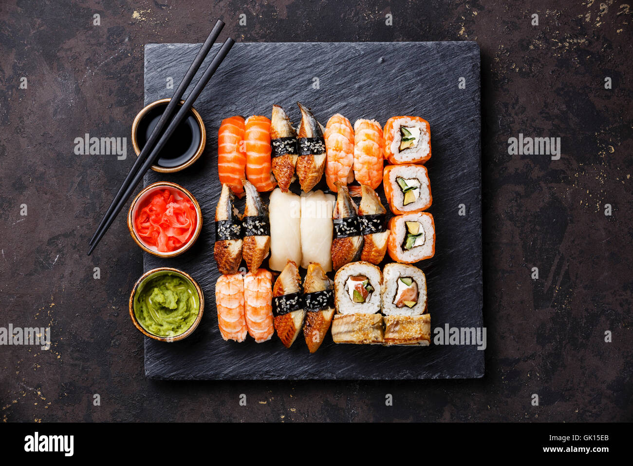 Sushi Set nigiri and sushi rolls on black stone slate plate board Stock ...