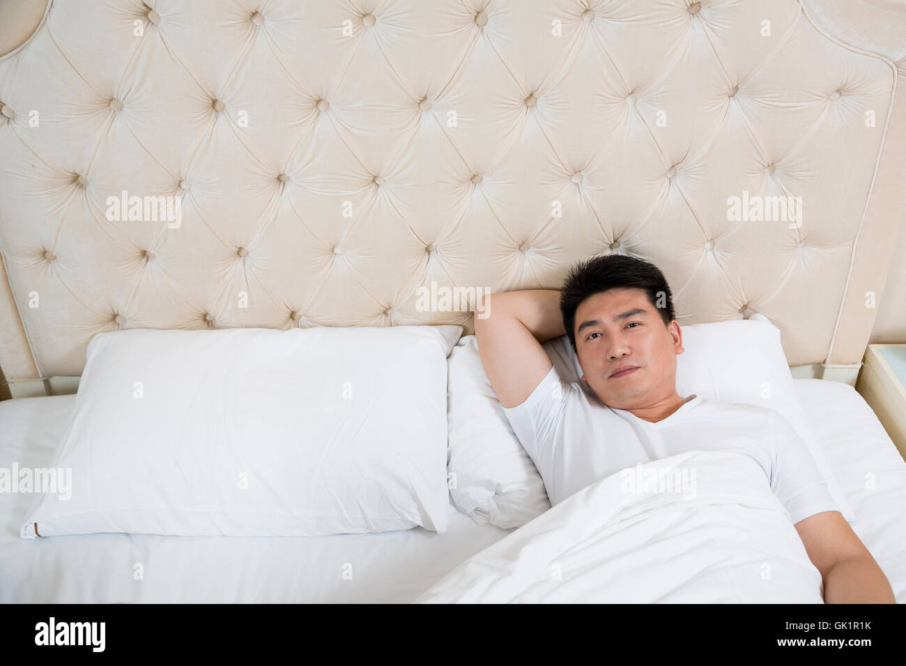 Middle-aged man in the bedroom to rest Stock Photo - Alamy