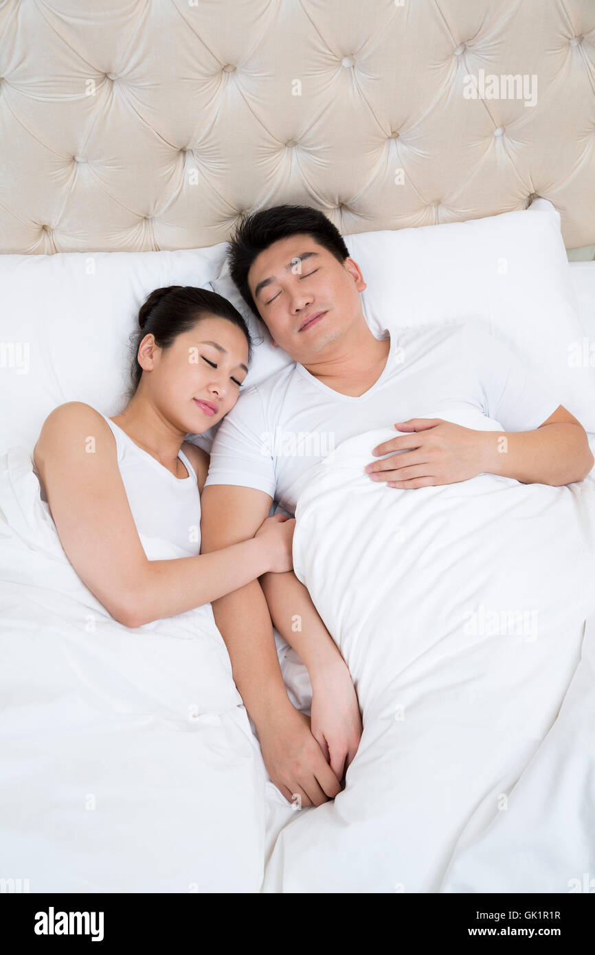 Couple resting in the bedroom Stock Photo - Alamy