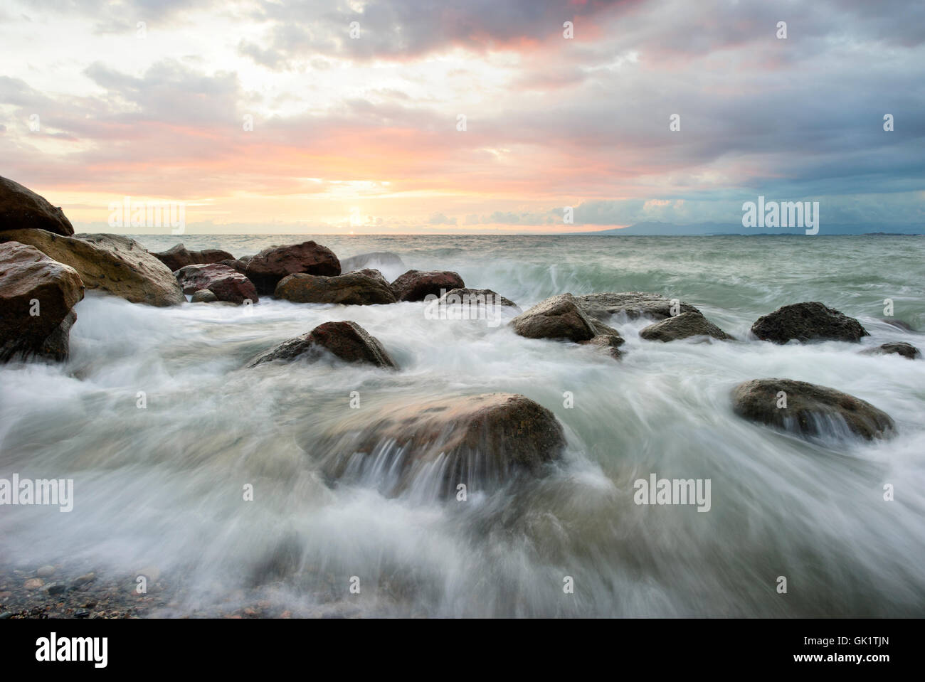 Ocean sunset is a beautiful scenic seascape with waves rushing and ...