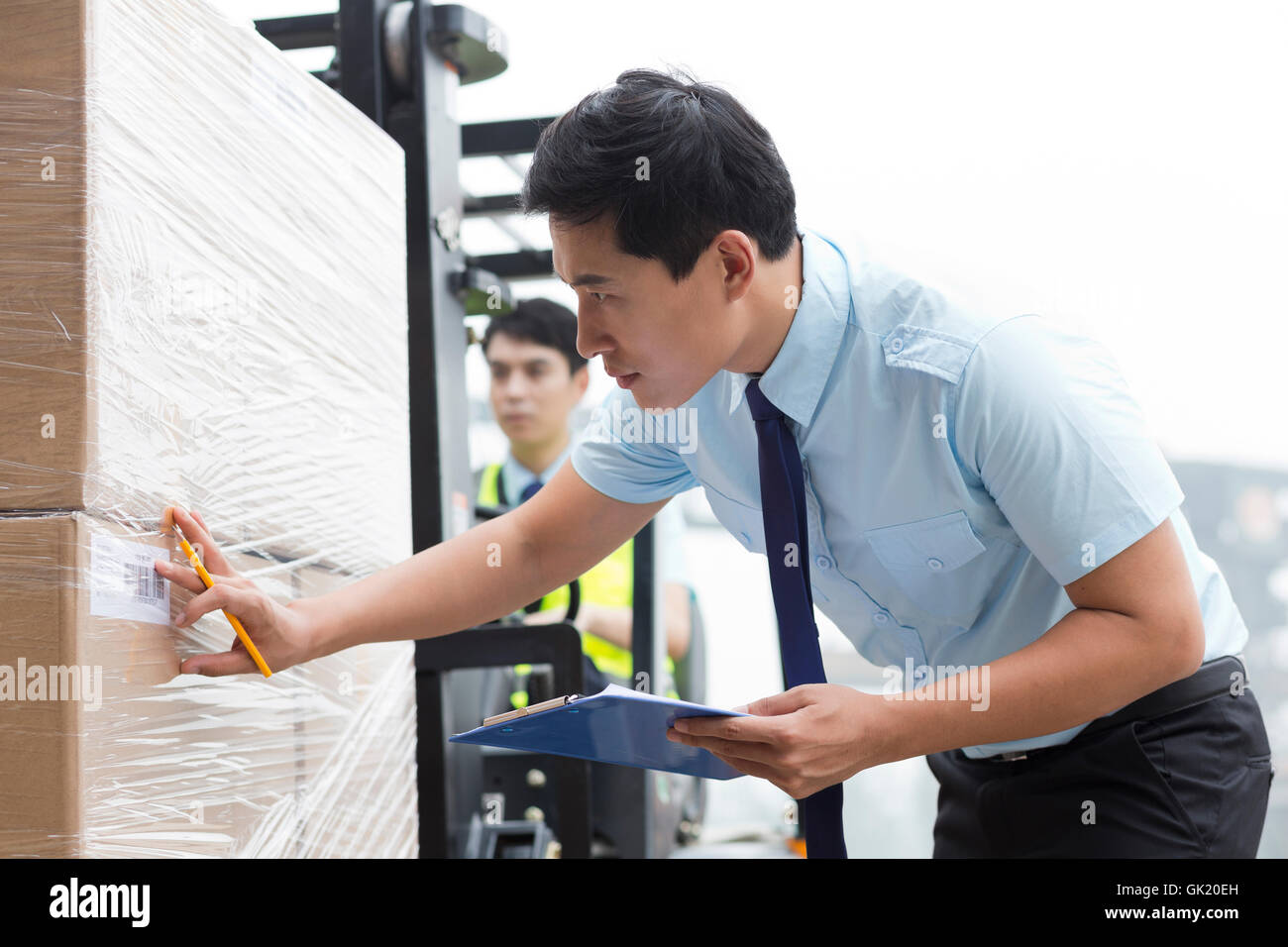 Logistics warehouse management personnel inspect the goods Stock Photo ...