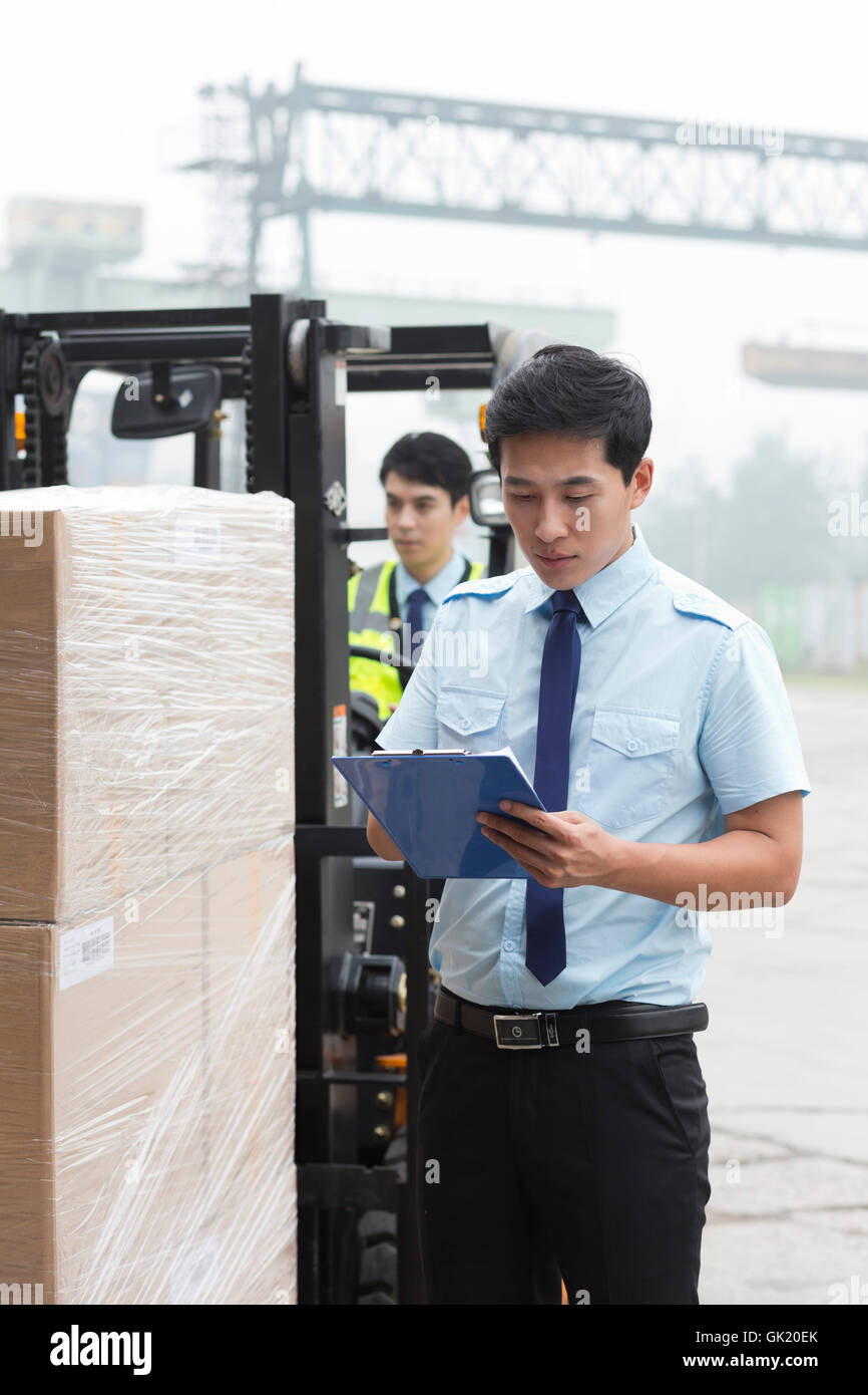 Logistics warehouse management personnel inspect the goods Stock Photo ...