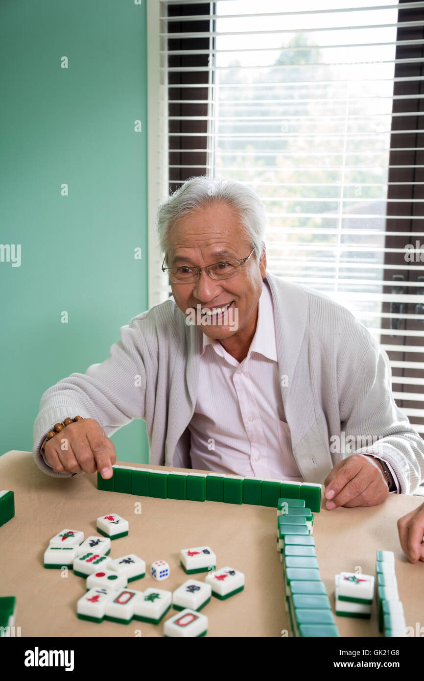 A people playing mahjong Stock Photo - Alamy