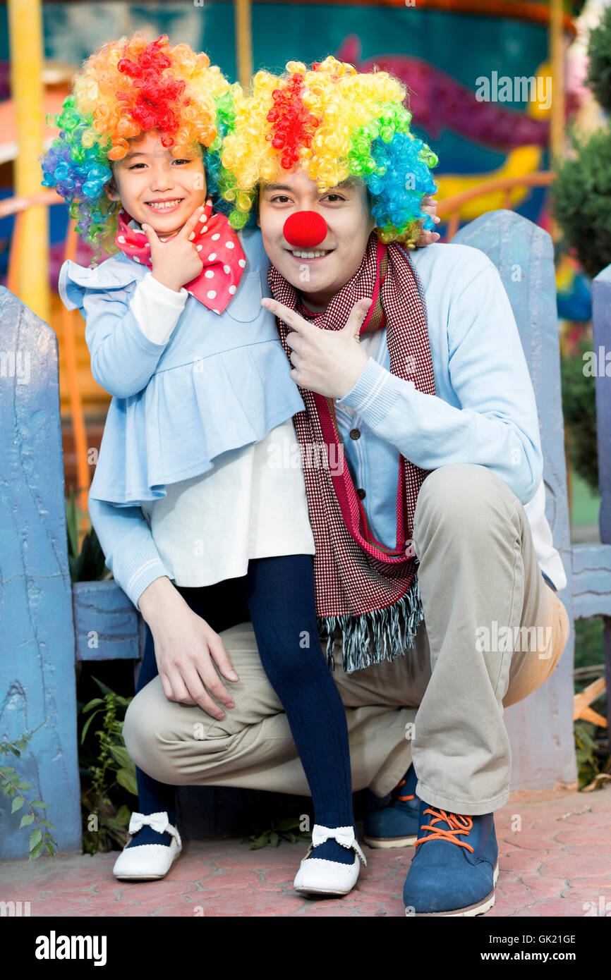 Happy father and daughter playing clowns at an amusement park Stock ...