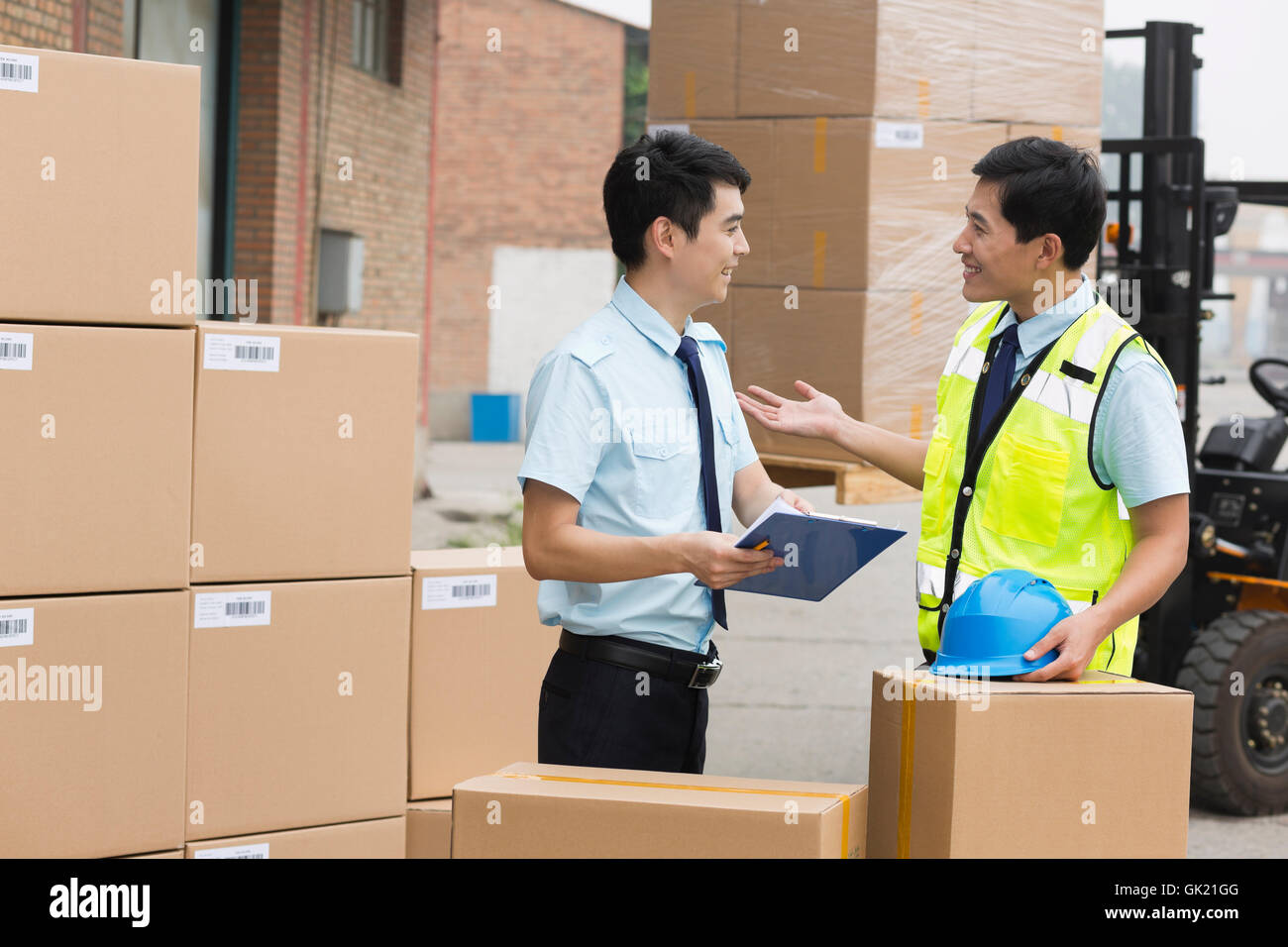 Logistics warehouse manager in communication Stock Photo - Alamy
