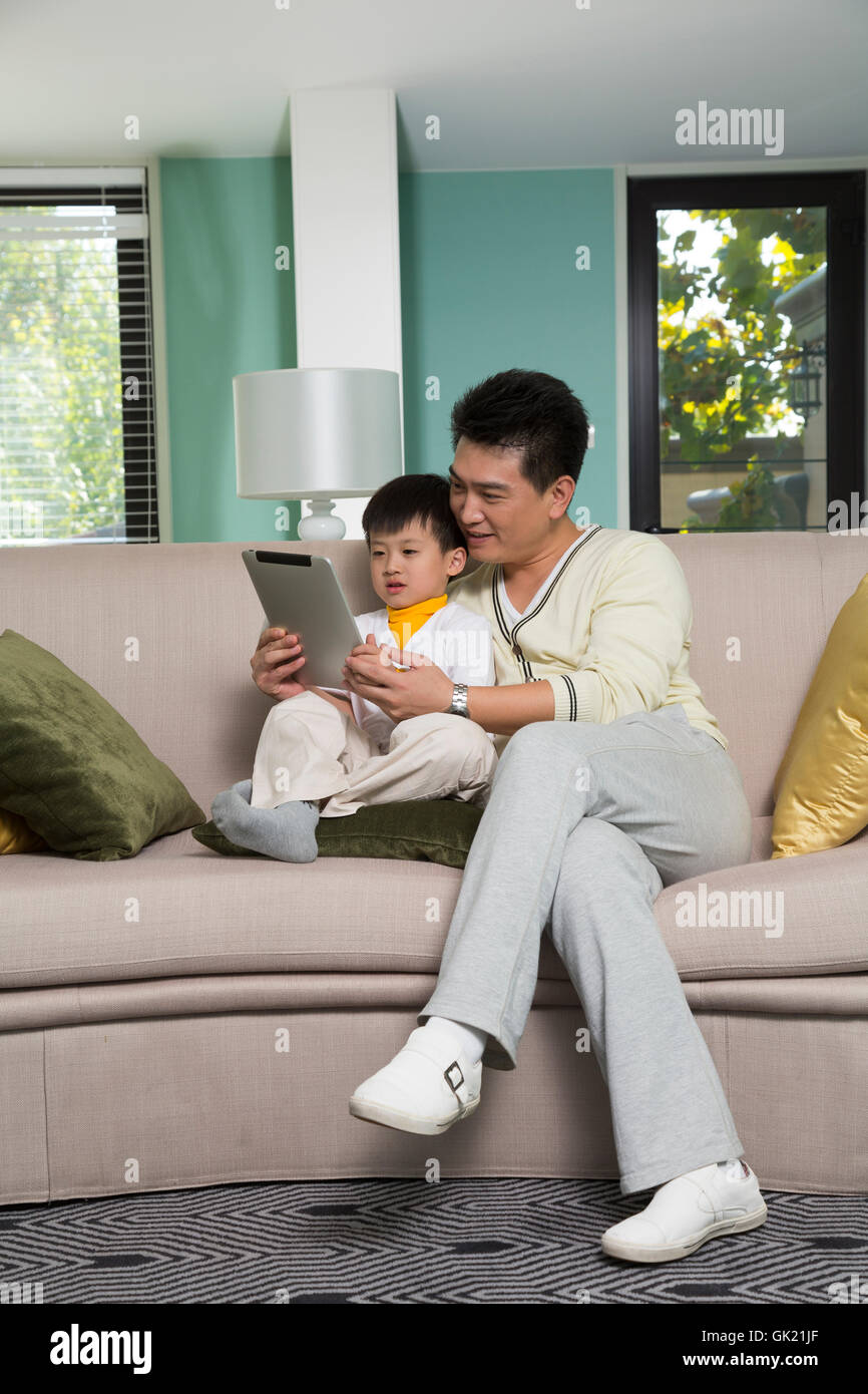 Father and son in the living room Stock Photo - Alamy