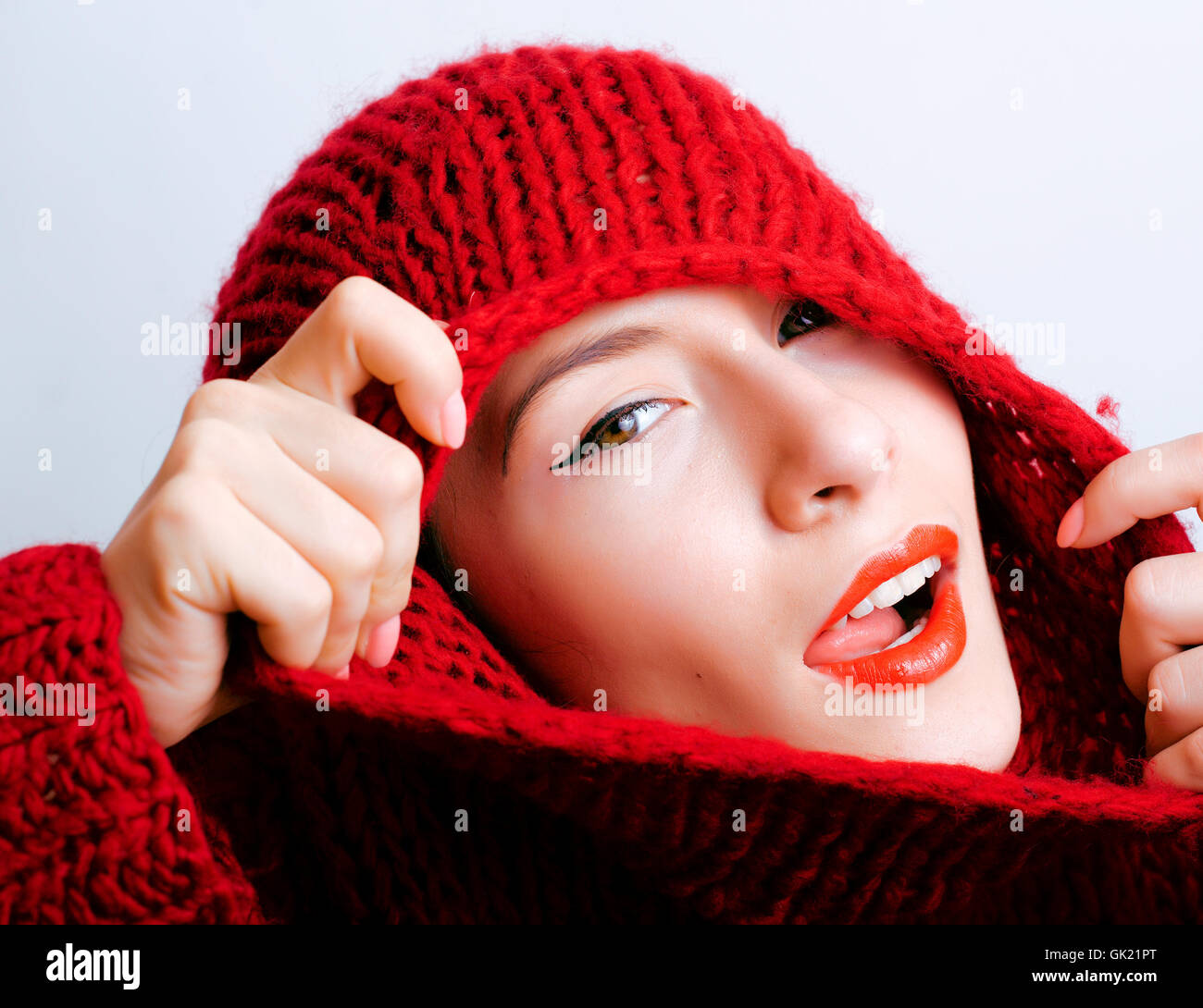 young pretty woman in sweater and scarf all over her face, winter cold ...