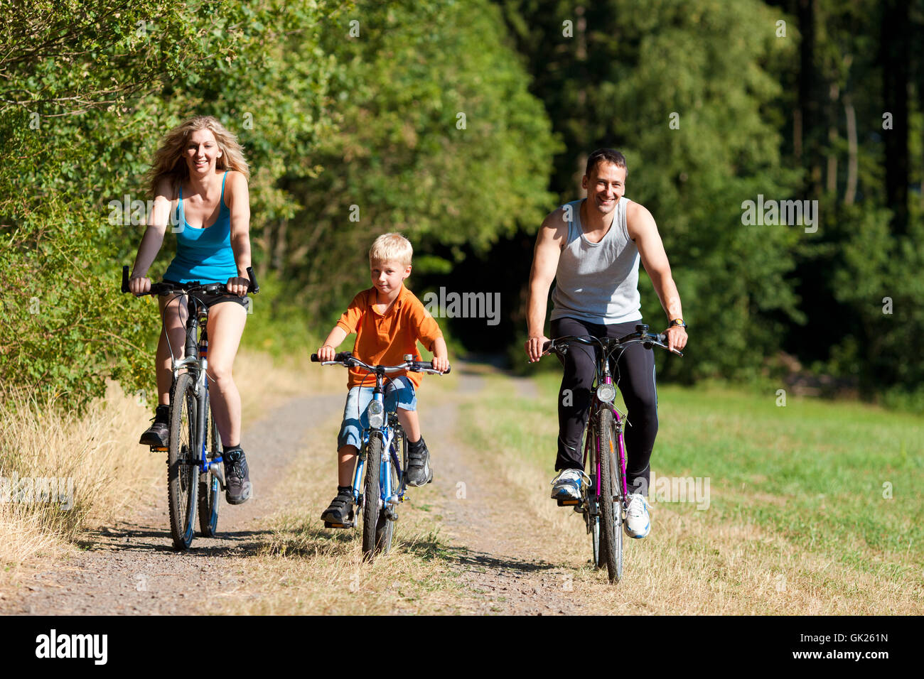 family rides a bike as a sport Stock Photo - Alamy