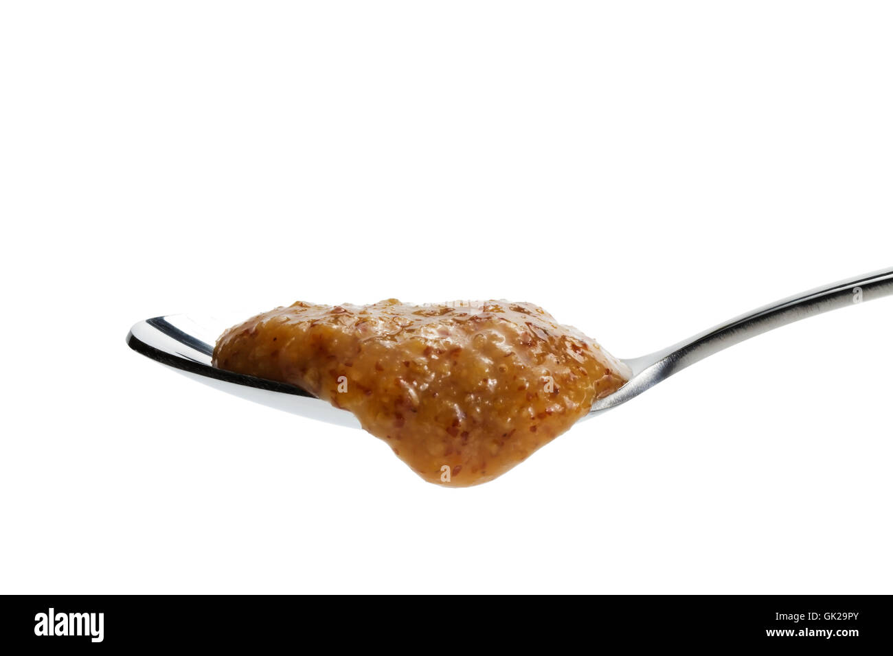 sweet mustard flows from a spoon isolated on white background Stock ...