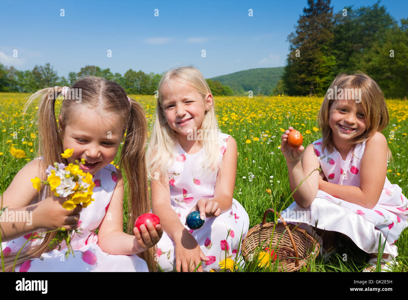 children on easter egg hunt with eggs Stock Photo - Alamy