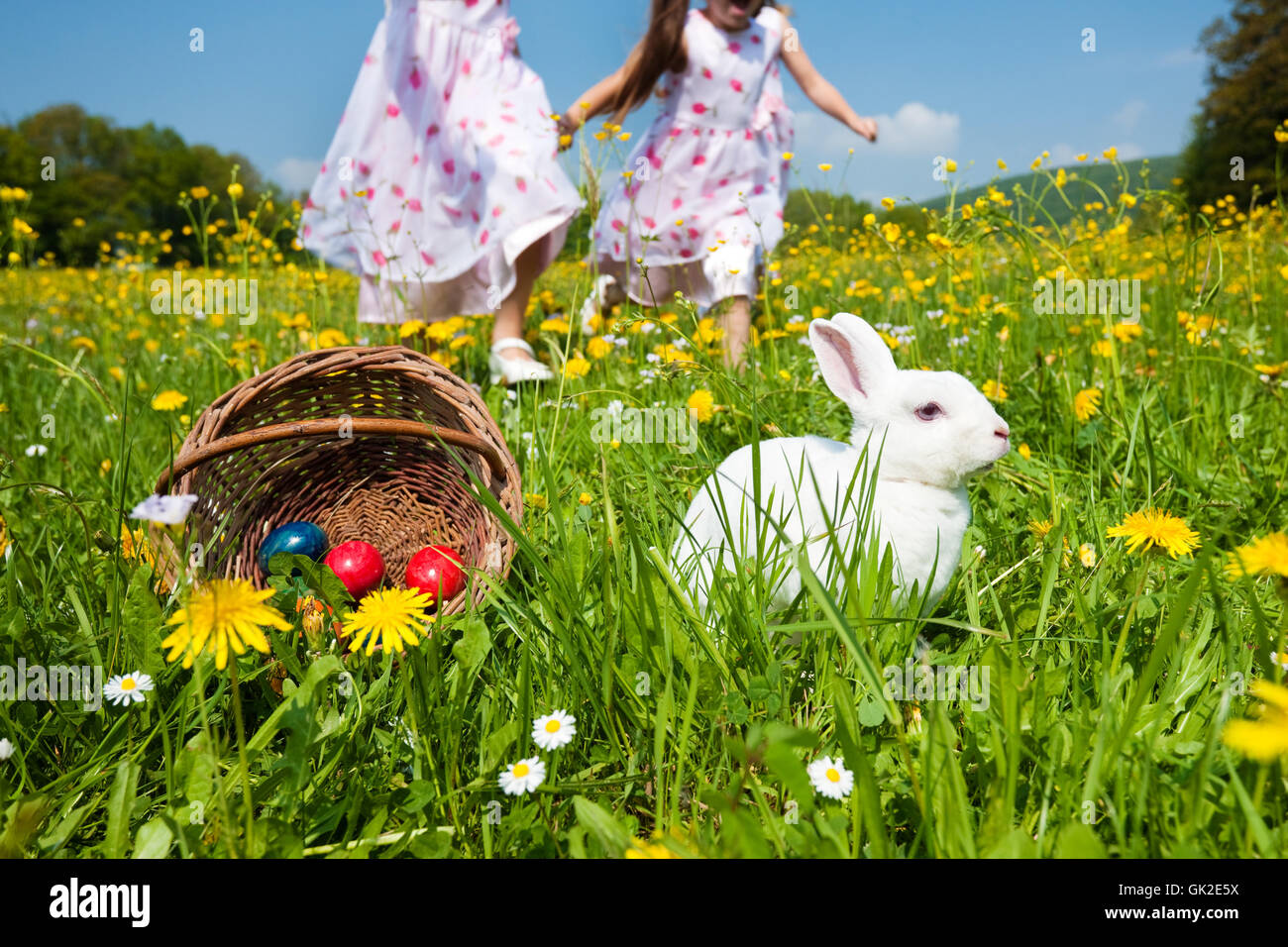 children on easter egg hunt with bunny Stock Photo - Alamy
