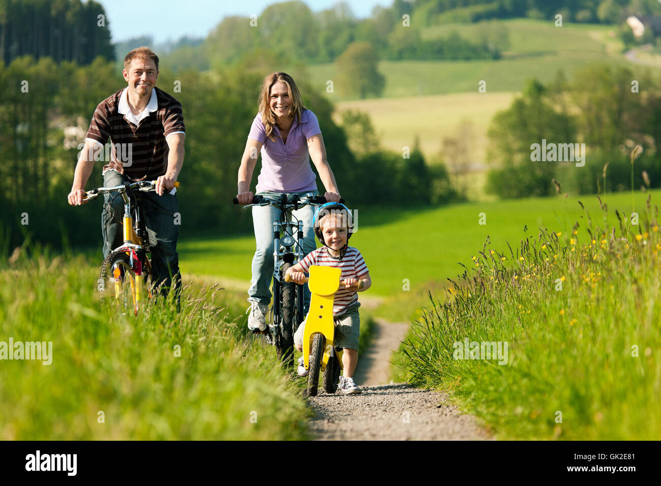 Active family three riding bikes hi-res stock photography and images ...