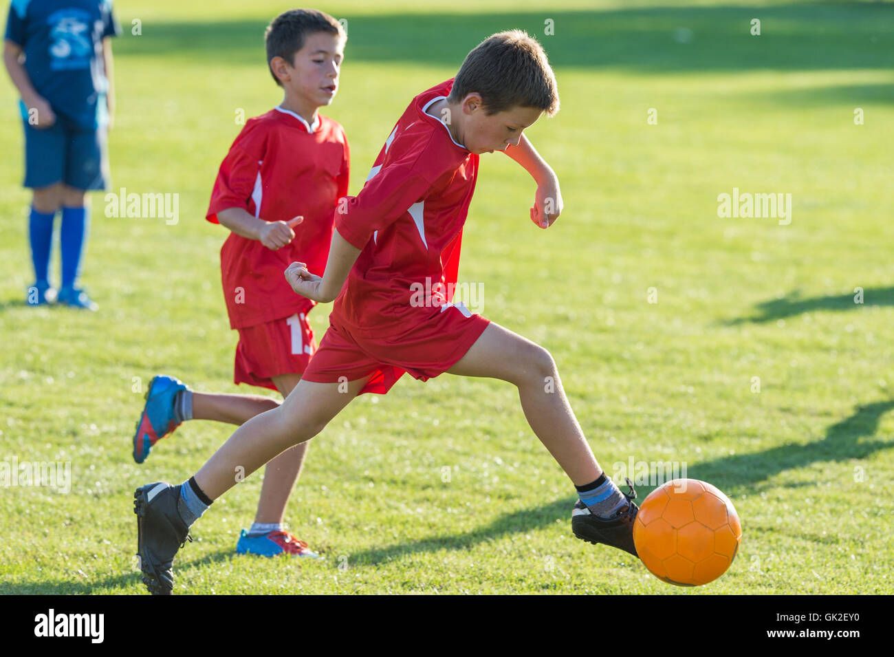 boys kicking football on the sports field Stock Photo - Alamy