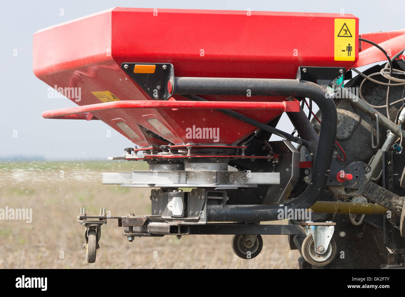 Tractor and fertilizer spreader in field Stock Photo - Alamy