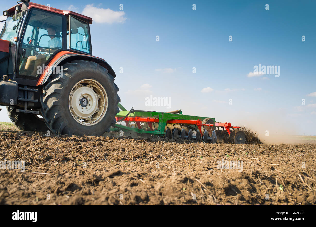 Tractor preparing land for sowing Stock Photo - Alamy
