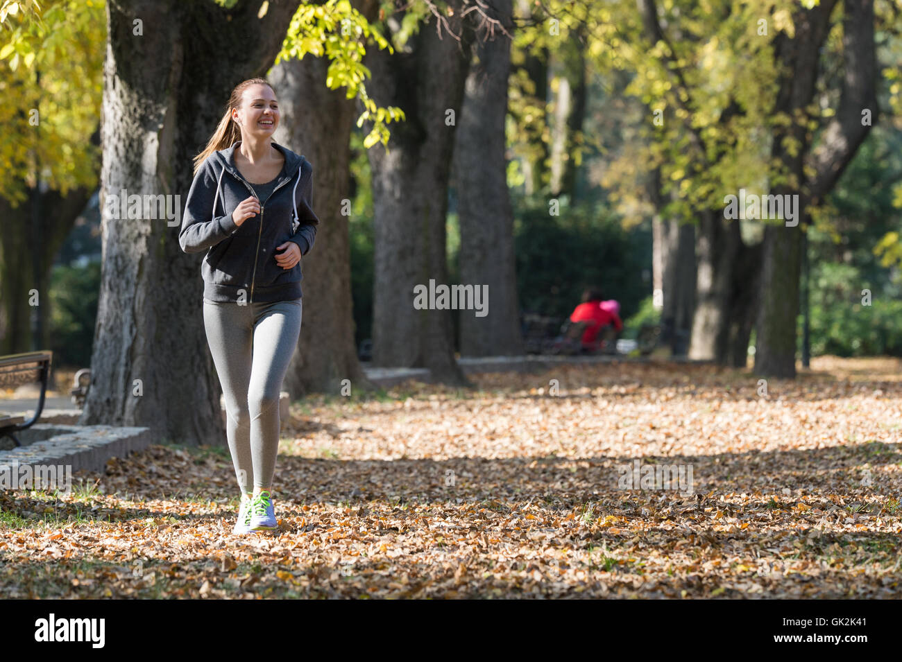 Pretty young girl jogging in the park Stock Photo - Alamy