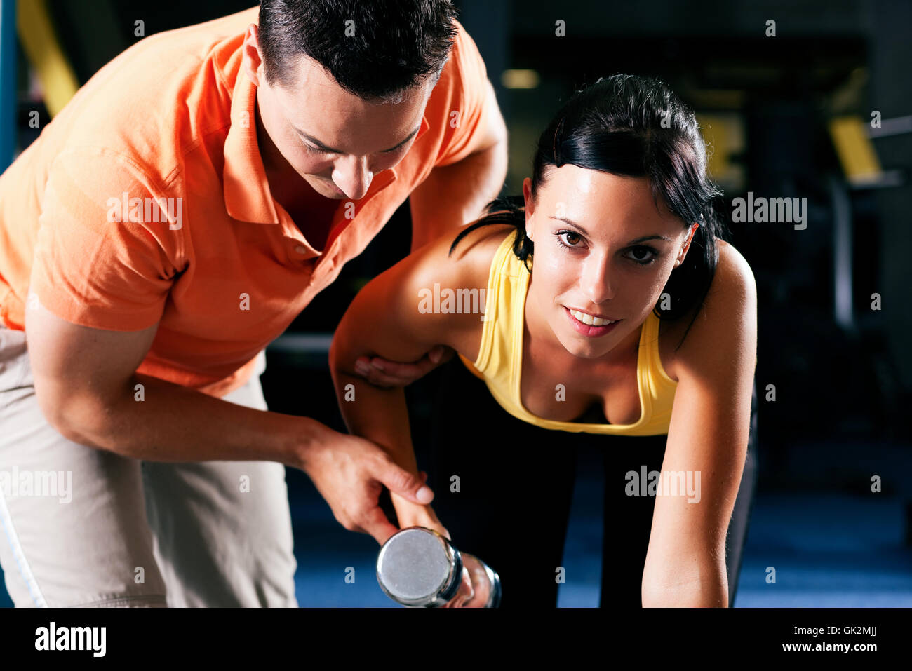 trainer and woman in gym Stock Photo - Alamy
