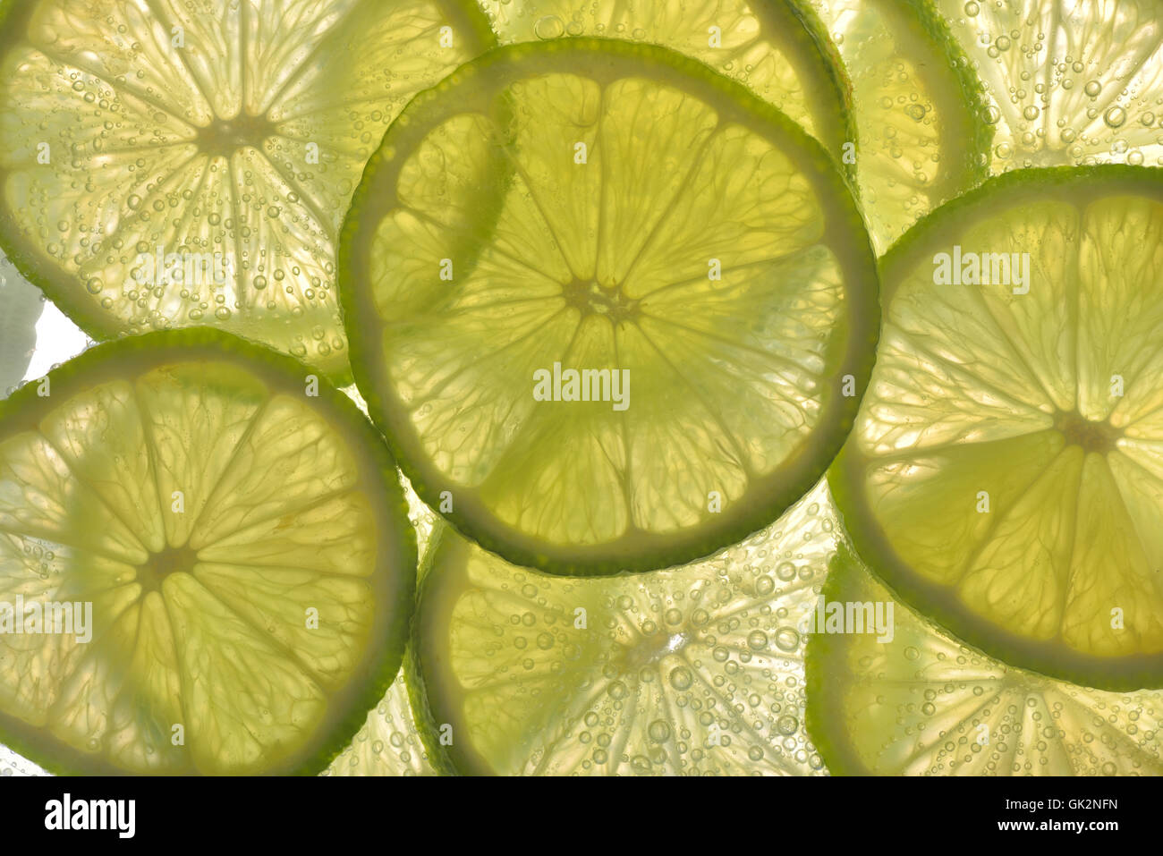 Lime slices in water with bubbles Stock Photo - Alamy
