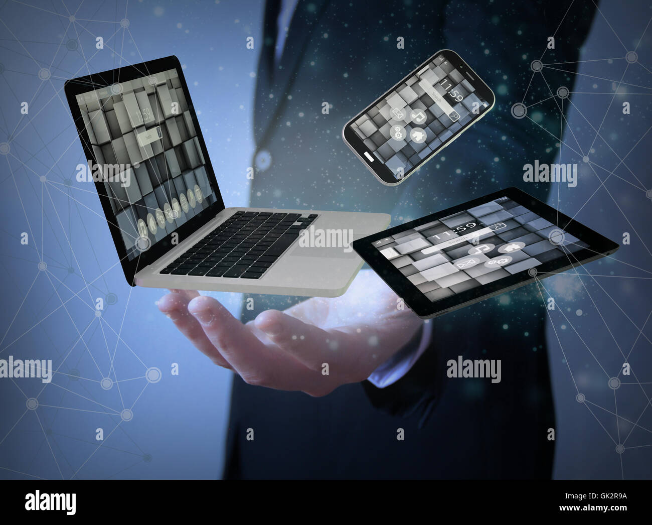 responsive devices over businessman hands. All screen graphics are made ...