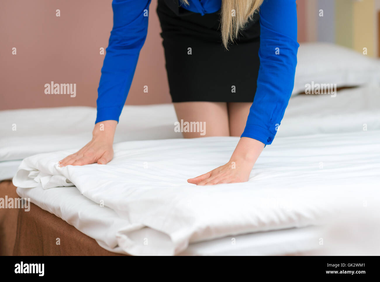 Room service. Woman making bed in hotel room Stock Photo - Alamy