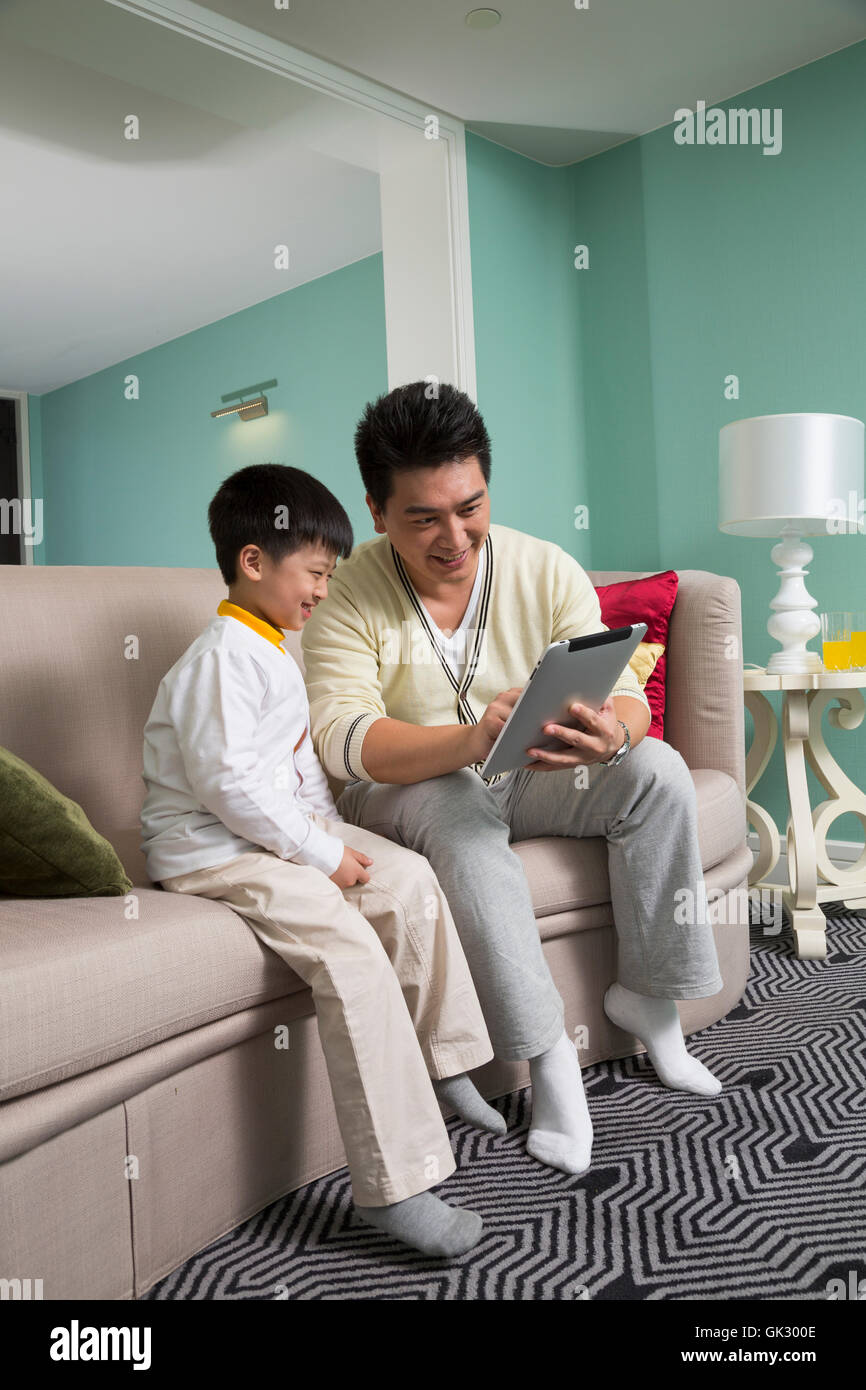 Father and son in the living room Stock Photo - Alamy