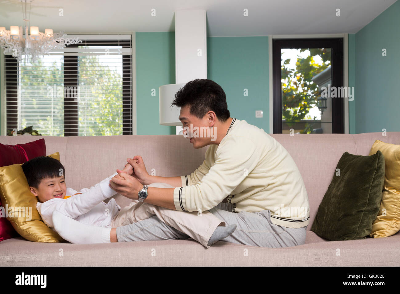 Father and son in the living room Stock Photo - Alamy