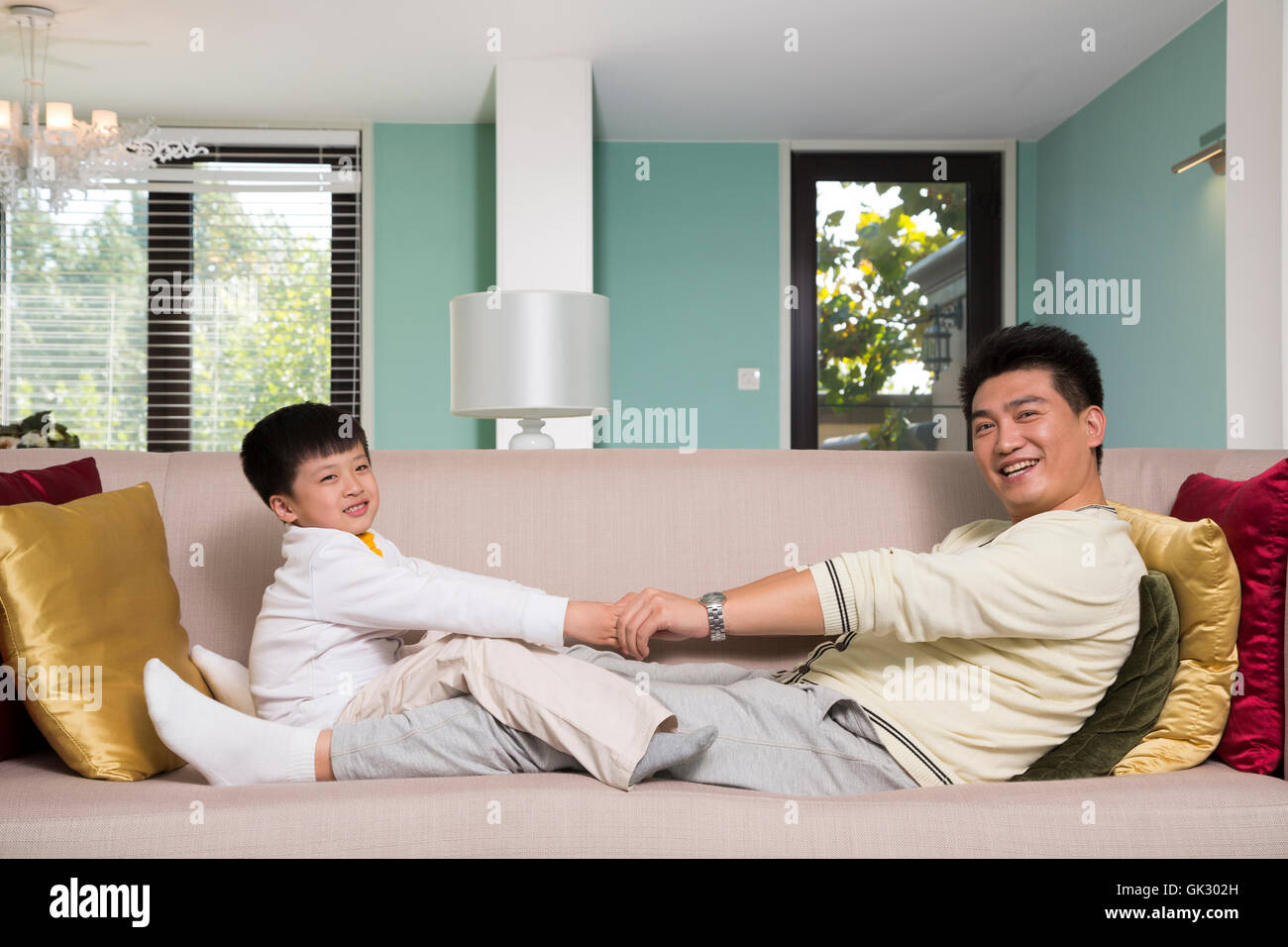 Father and son in the living room Stock Photo - Alamy